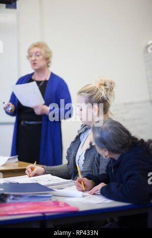teacher in a classroom teaching ESOL, English for speakers of other ...