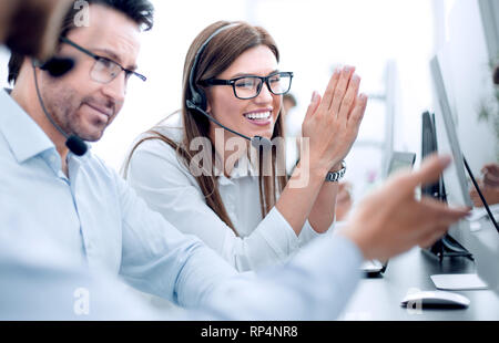 happy call center employees sitting at their Desk Stock Photo - Alamy