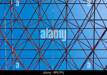 Image shows an abstract celling metal construction on blue sky ...