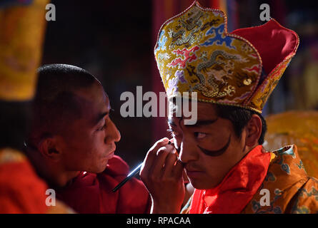 Buddhist monks performing ritual before elaborately decorated shrine on ...