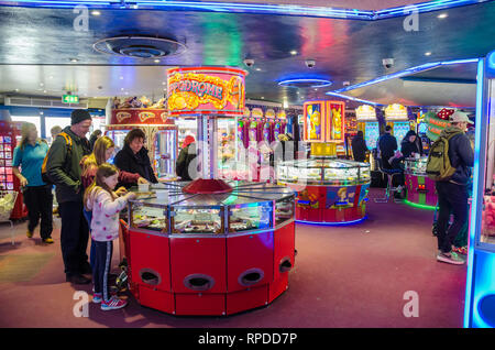 People play on amusement machines inside arcade in New Brighton Wirral ...