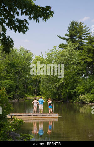 A woman and children observing something Stock Photo - Alamy