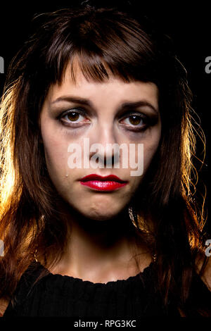 smeared make-up by crying tears on a noir style sad woman Stock Photo ...