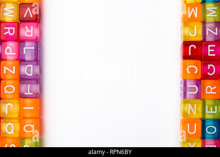 Lots of colorful decorative cubes with letters on white background. The ...