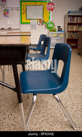 School classroom with three-row desks and large windows. Student ...