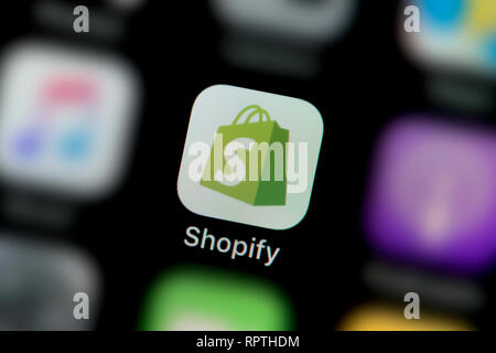 A close-up shot of the Shopify app icon, as seen on the screen of a ...
