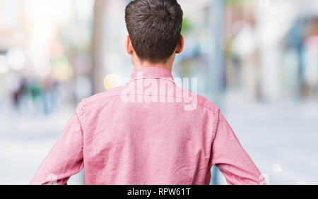 Hispanic man standing over pink background pointing unhappy to pimple ...