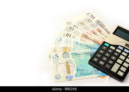 Counting British pound isolated by calculator on white background Stock ...