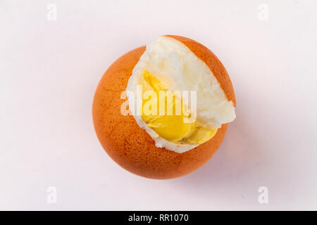 Cracked exploded egg with yoke showing isolated on a white background ...