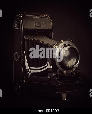 Vertical aspect right side view of a vintage bellows film camera ...