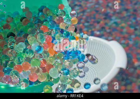 Falling multicolored water beads Stock Photo - Alamy