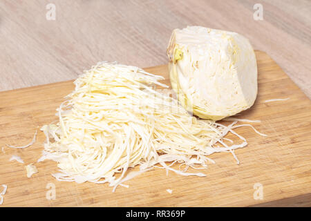 finely chopped cabbage closeup on wooden background Stock Photo - Alamy