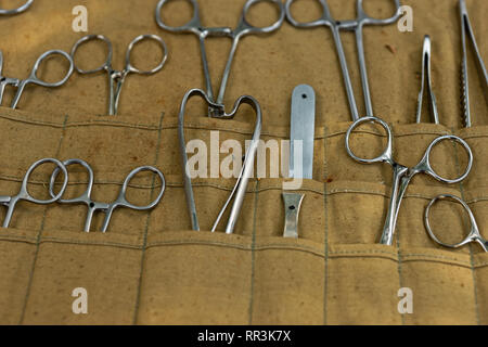 Set of nineteen-century military surgical instruments and tools lay on ...