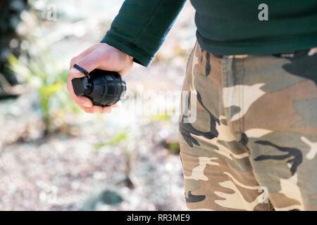 Soldier holding hand grenade on white background, closeup Stock Photo ...