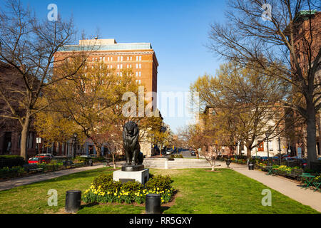 Baltimore, Maryland: Statue of a seated lion and luxury apartment ...