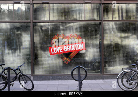 Love Brixton heart sign in a window and bikes on a street in Brixton ...
