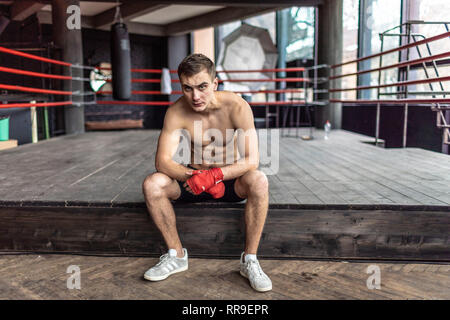Professional male boxer sitting in the corner of the boxing ring Stock ...