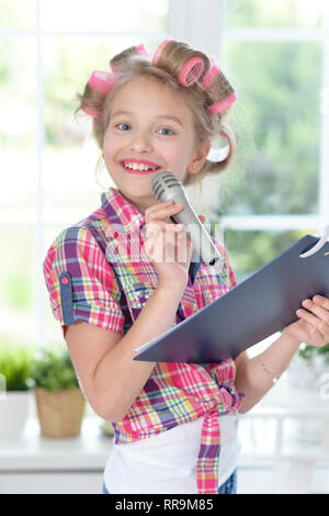 Adorable little girl singing karaoke Stock Photo - Alamy