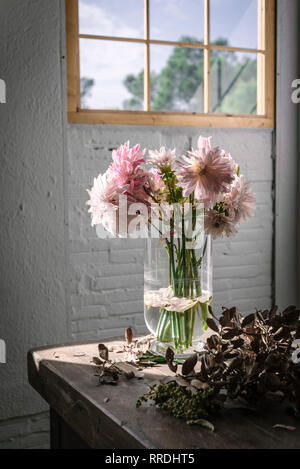 Concept of bouquet of dry coniferous twigs in craft paper on table near ...