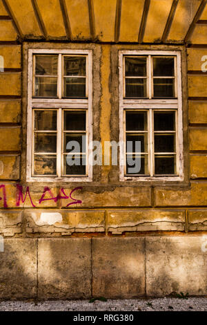 Windows of old house on wall mantled with ivy Stock Photo - Alamy