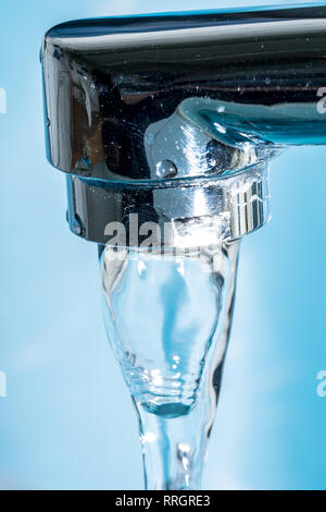 Water flow from chromed steel faucet Stock Photo - Alamy