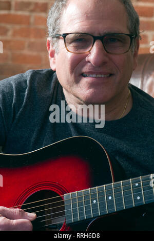 Middle age handsome singer man singing using microphone over isolated ...