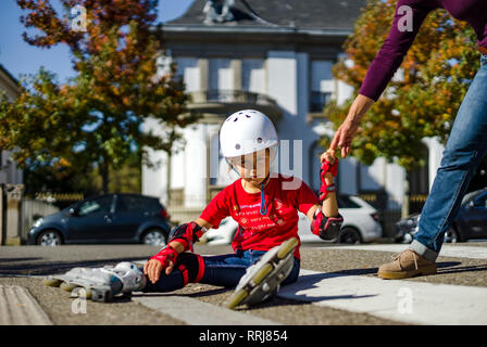 little child girl falled down while rolling with her mother in park ...