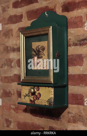 old silver pocket watch hanging from a red ribbon with abstract ...