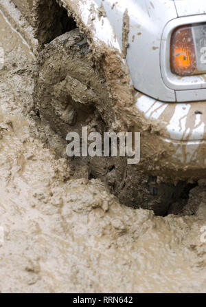 wheel of an off-road car buried in the mud during a competition Stock ...