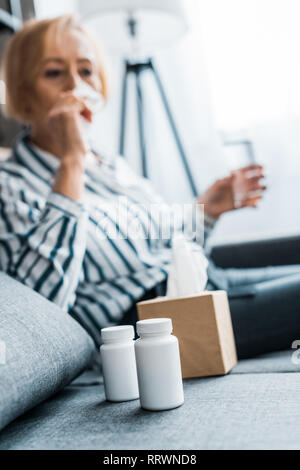 selective focus of tissue box on bedding near depressed woman Stock ...
