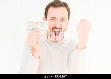 Senior man holding twenty dollars bank note over isolated background ...