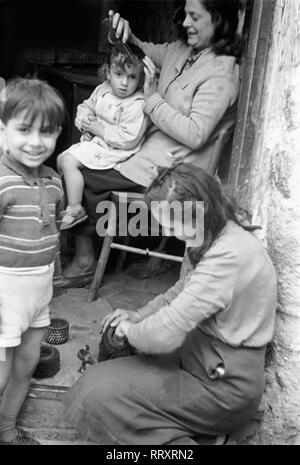 Children in Naples, Italy. Little boy helps one-legged companion across ...