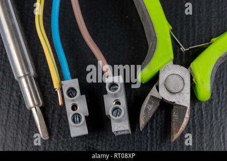 Electrical wires mounted to an electrical outlet. Electrical ...