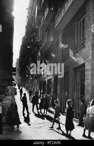 Children in Naples, Italy. Little boy helps one-legged companion across ...
