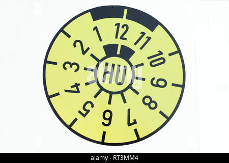 Yellow TÜV sticker Stock Photo - Alamy