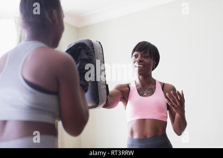 Mother teaching daughter boxing Stock Photo - Alamy