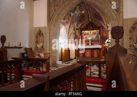 The altar of a High Church Anglican church with candles and a picture ...