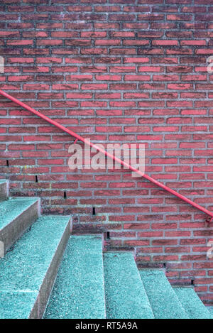 Side view of concrete steps and railing leading to an entrance in a ...