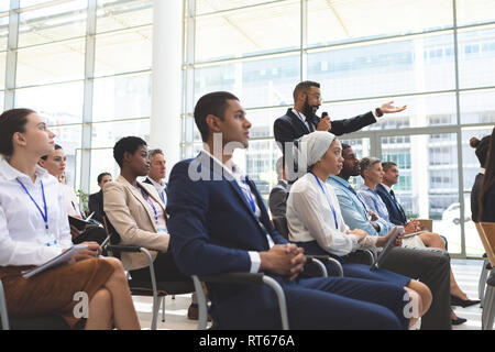 Businessman asking question during seminar Stock Photo - Alamy