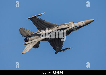 An air-to-air view of an upside down F-16 Fighting Falcon aircraft as ...