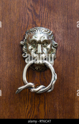 A closeup of the door with silver knob of a classic red Goggomobil T250 ...