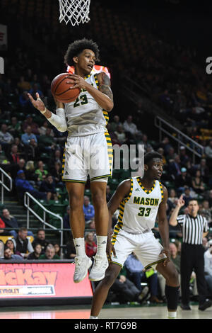 George Mason guard Javon Greene, left, goes up for a shot against ...