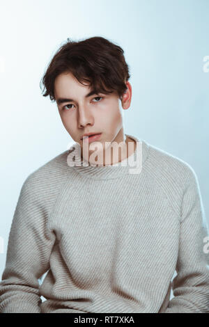 young handsome teenage hipster guy posing emotional, happy smiling ...