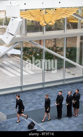 A newly graduated Naval Flight Officer poses for a photo with family ...