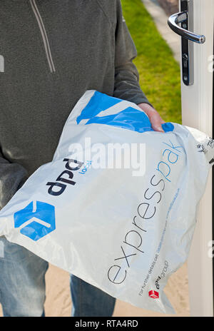 Man holding DPD expresspak package Stock Photo - Alamy