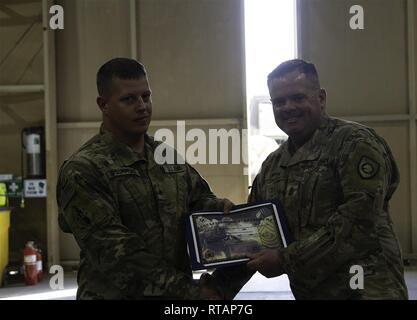 Command Sgt. Maj. Roderick Upton, 300th Sustainment Brigade, receives a ...