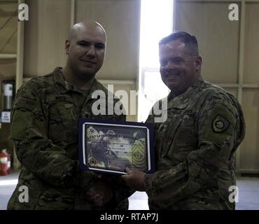 Command Sgt. Maj. Roderick Upton, 300th Sustainment Brigade, receives a ...