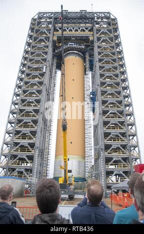 Members of a NASA-led tour group look up at the 215-foot-tall ...