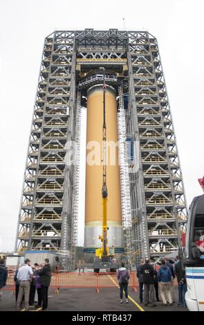 Members of a NASA-led tour group look up at the 215-foot-tall ...