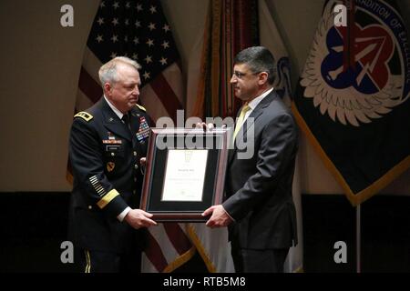 The Senior Executive Service certificate and SES pin is in place before ...